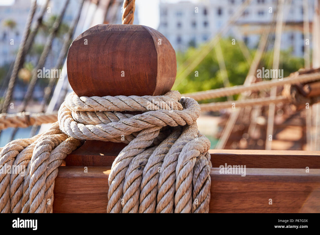 Marine background, sailing boat block with old rope Stock Photo - Alamy