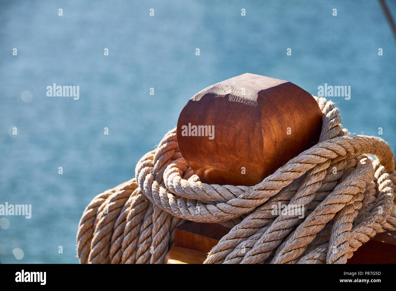 Marine background, sailing boat block with old rope Stock Photo - Alamy