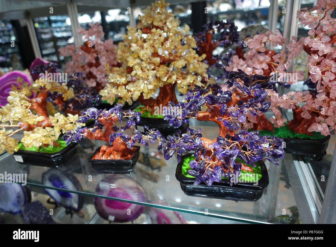 Colourful crystal gemstone trees on display Stock Photo - Alamy
