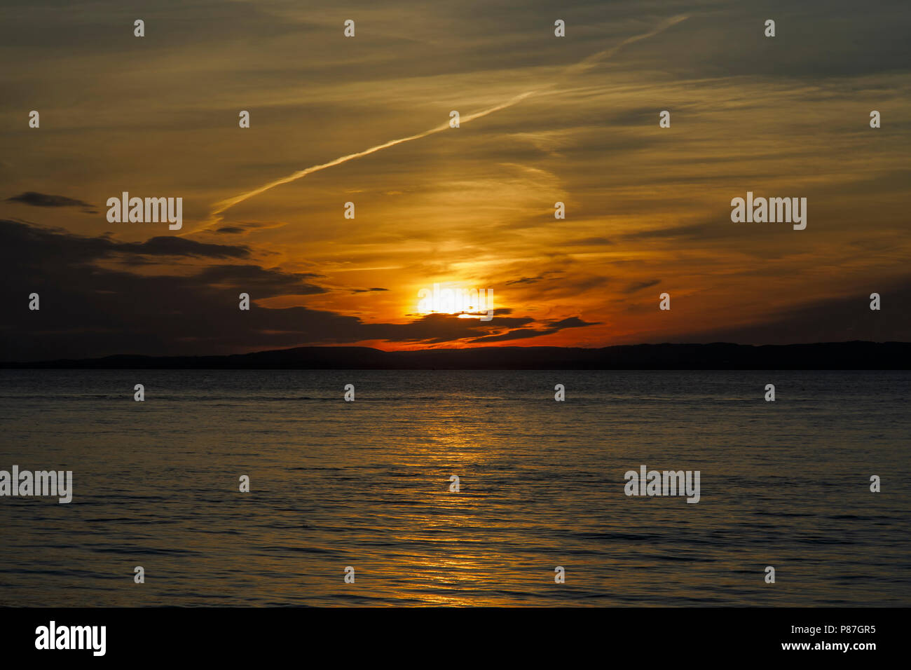 The sun setting Stock Photo - Alamy