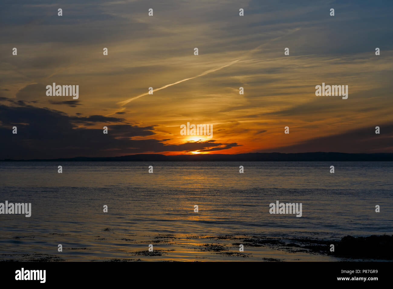 The sun setting Stock Photo - Alamy