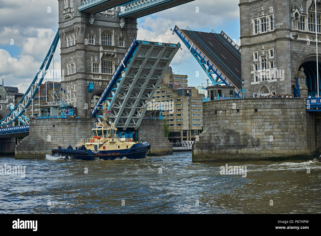 Tower Bridge across the River Thames in London opening to allow the ...