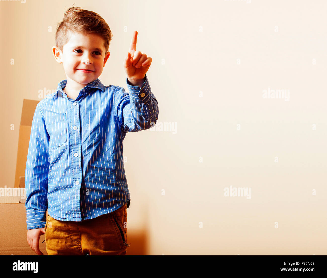 little cute boy in empty room, remoove to new house. home alone Stock ...
