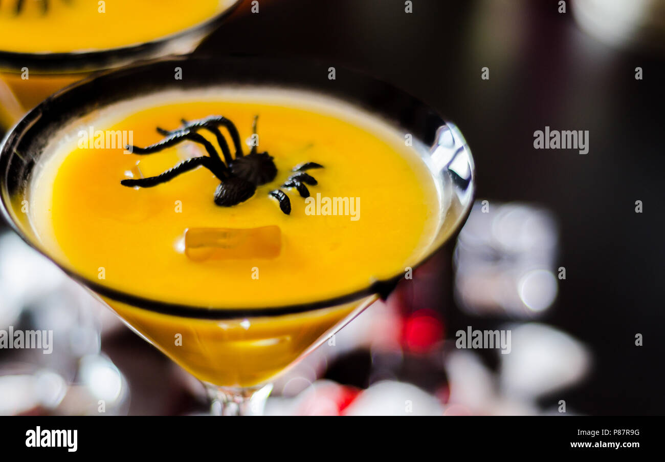 creepy halloween party cocktails with blood, spiders and ice cubes ...