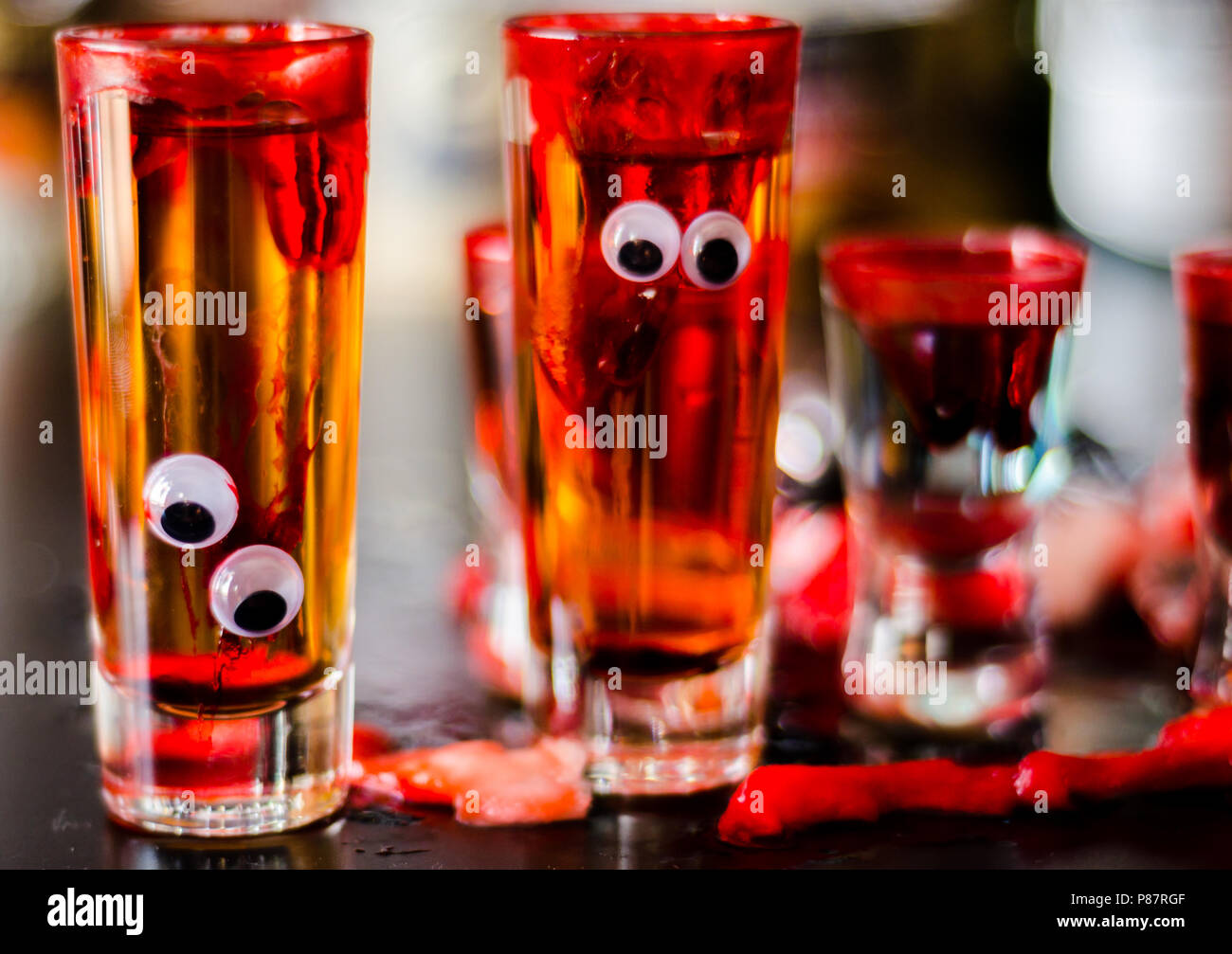 creepy halloween party cocktails with blood, spiders and ice cubes ...