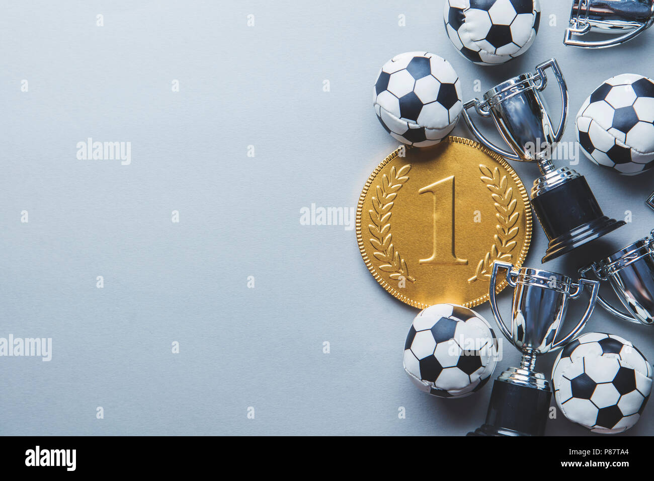 Gold first place winners medal and trophy with a soccer ball. Football ...