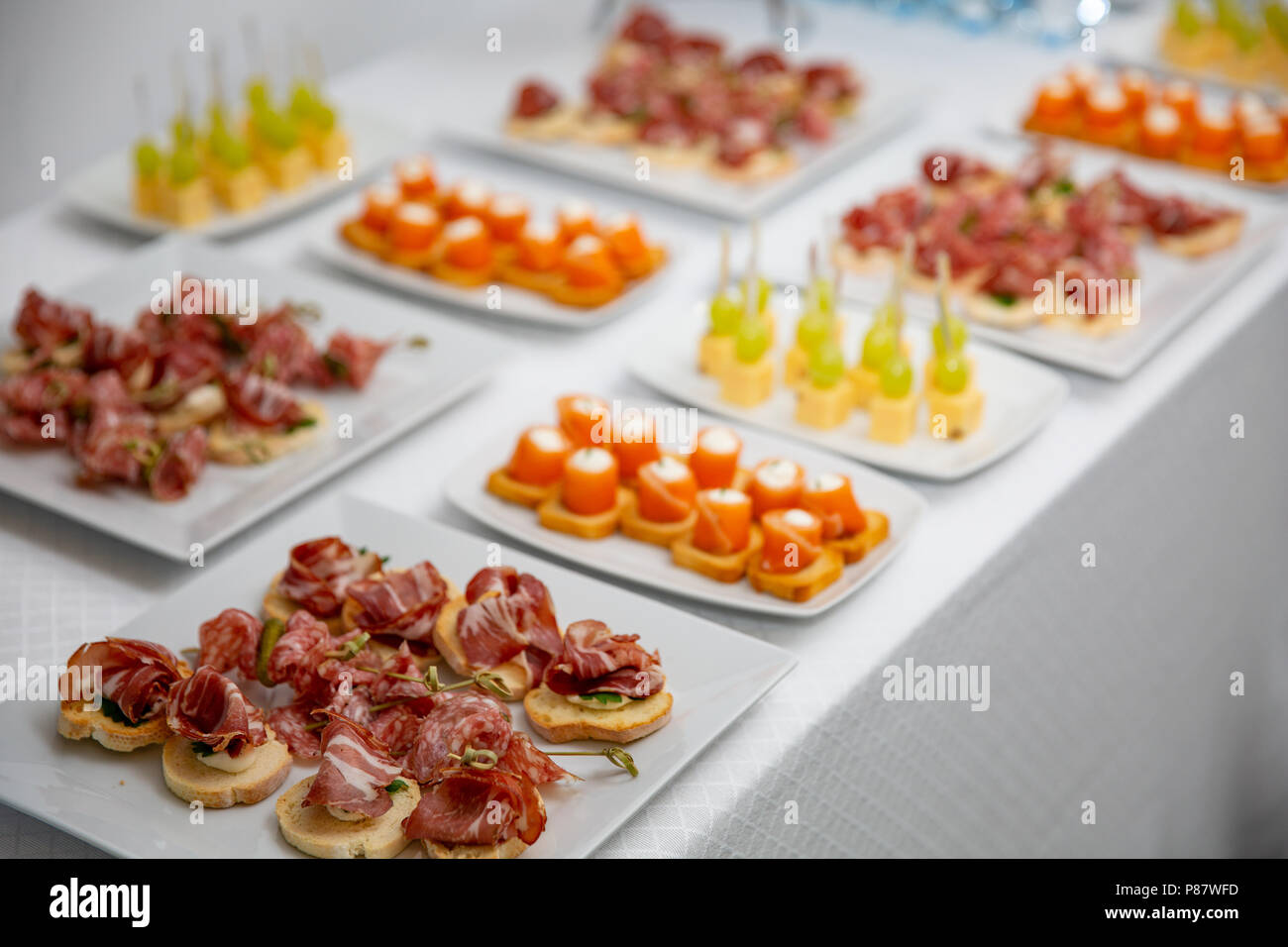 Set a variety of canapes and snacks on a table at the restaurant to ...