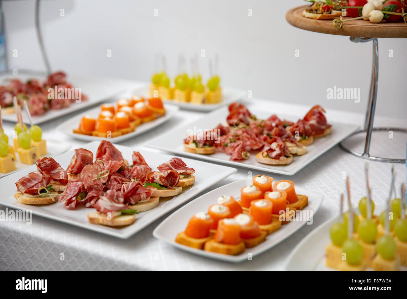 Set a variety of canapes and snacks on a table at the restaurant to ...