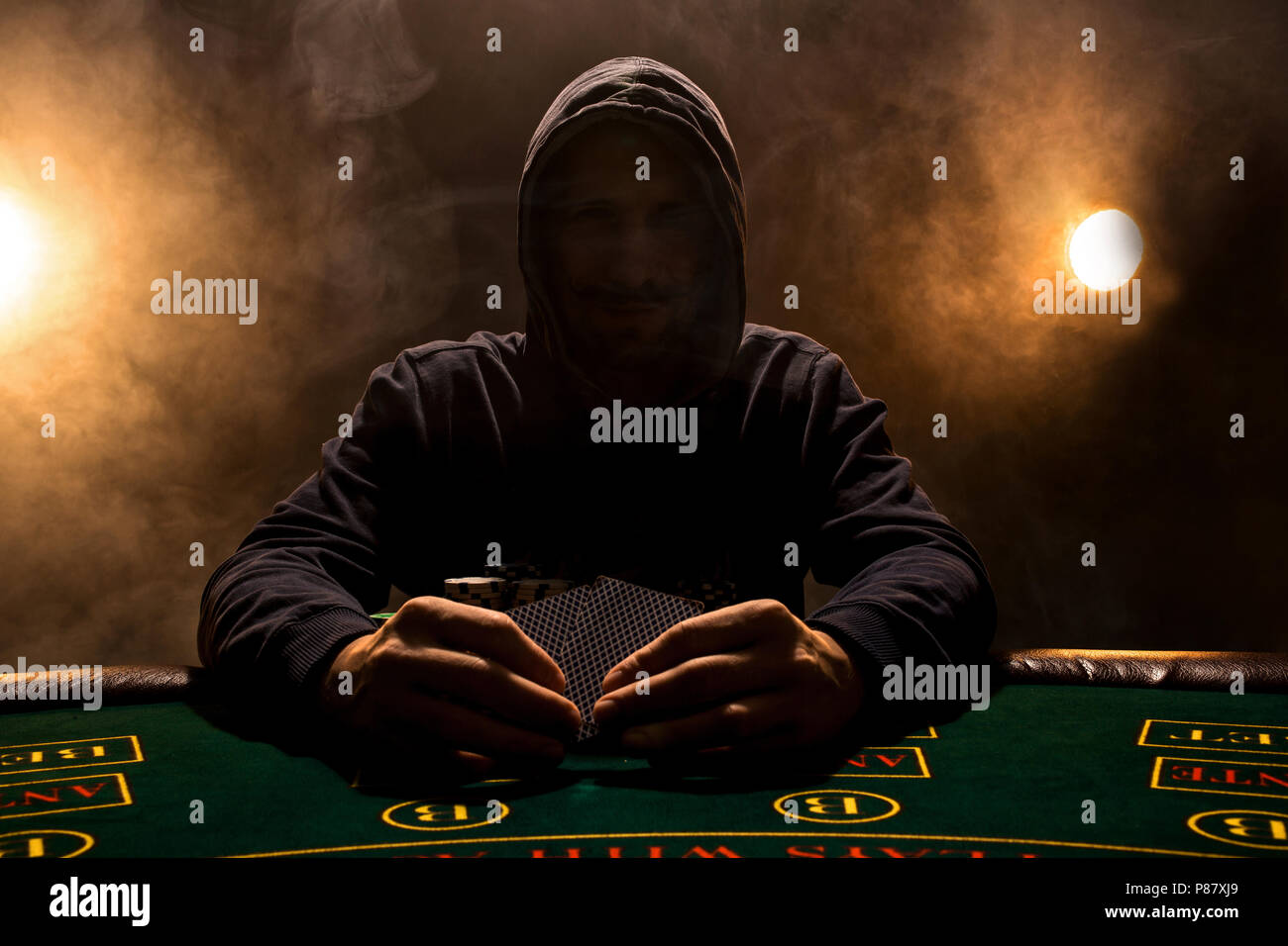 Portrait of a professional poker player sitting at pokers table Stock ...