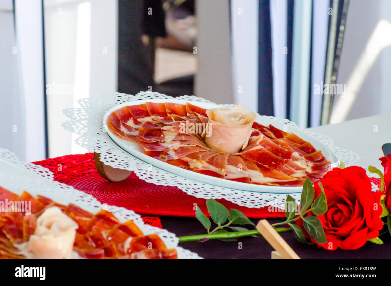plate with cut slices of jamon serrano, traditional Spanish ham, meat ...