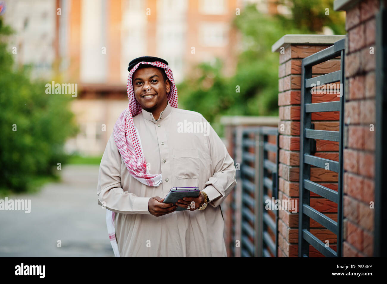 Middle Eastern arab man posed on street against modern building with ...