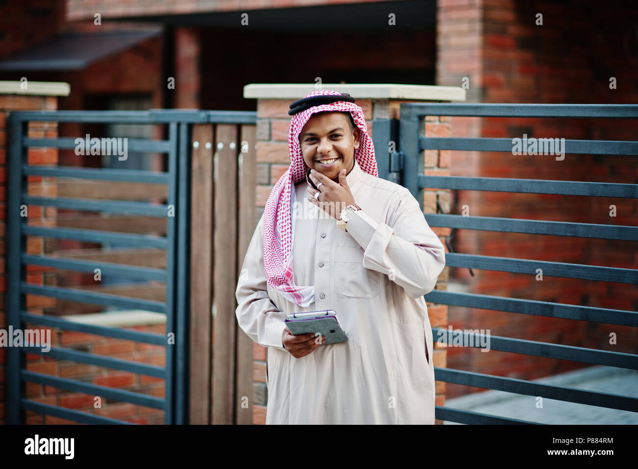 Middle Eastern arab man posed on street against modern building with ...