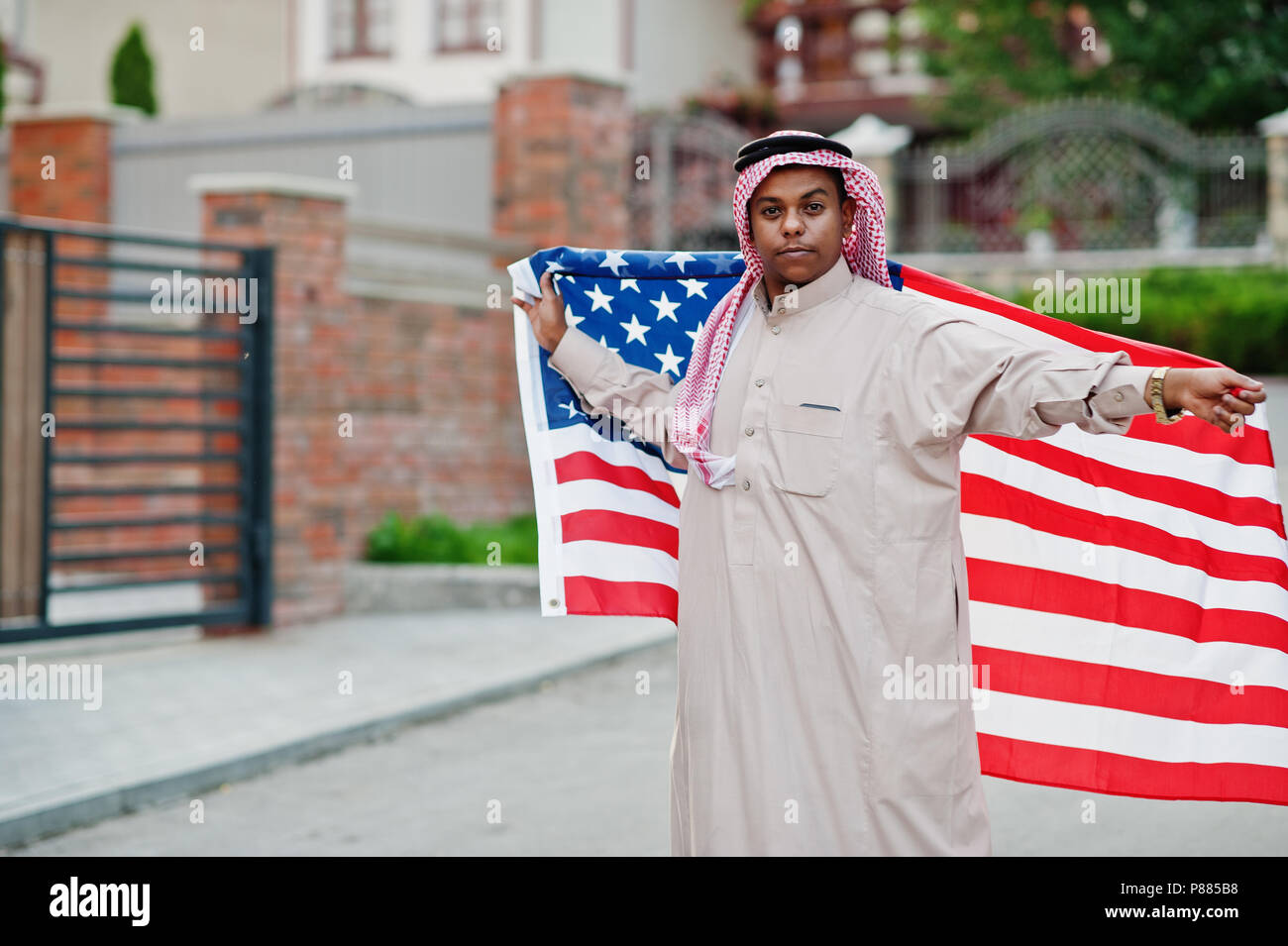 Middle Eastern arab man posed on street with USA flag. America and ...