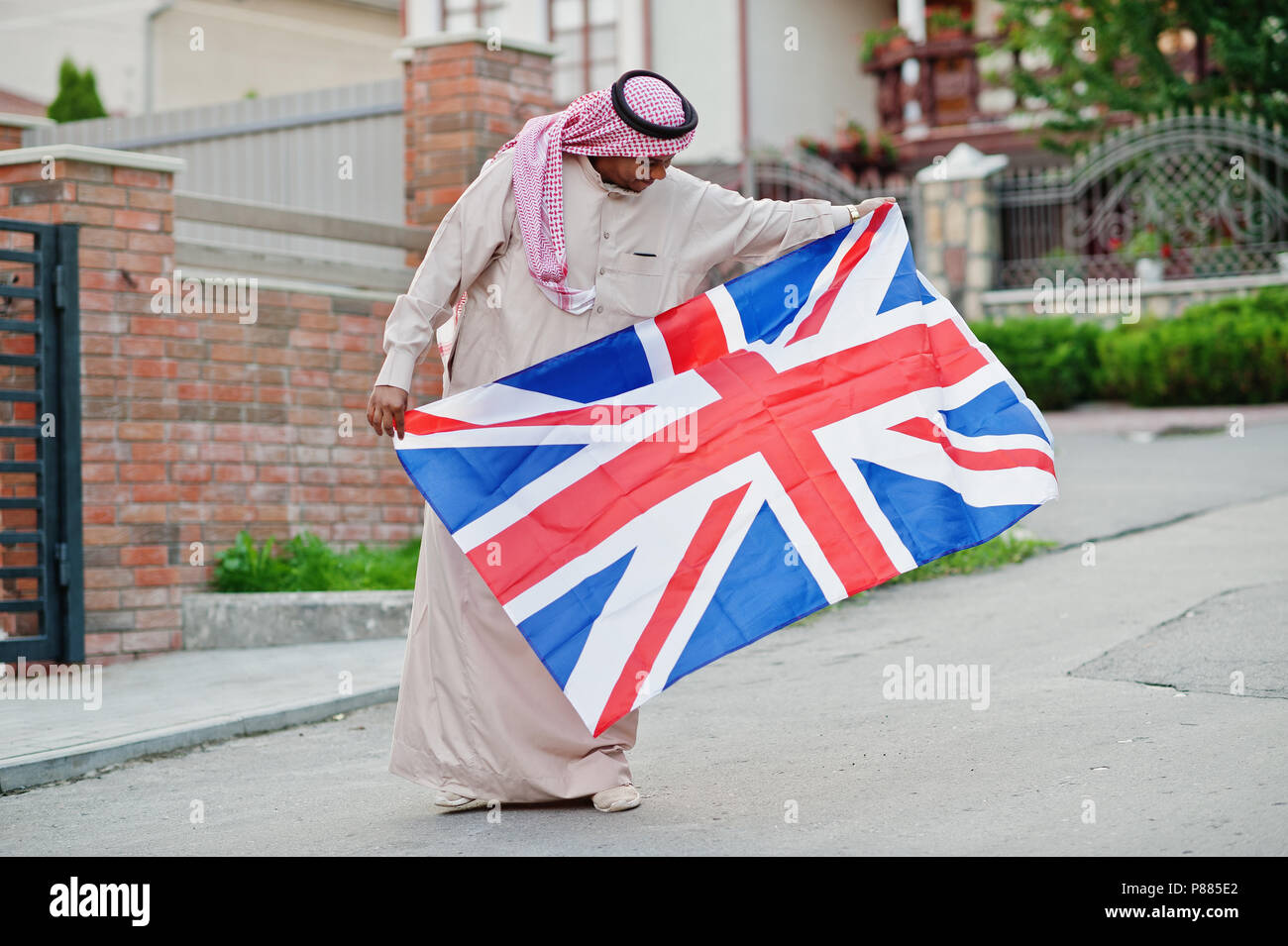 Middle Eastern arab man posed on street with Great Britain flag ...