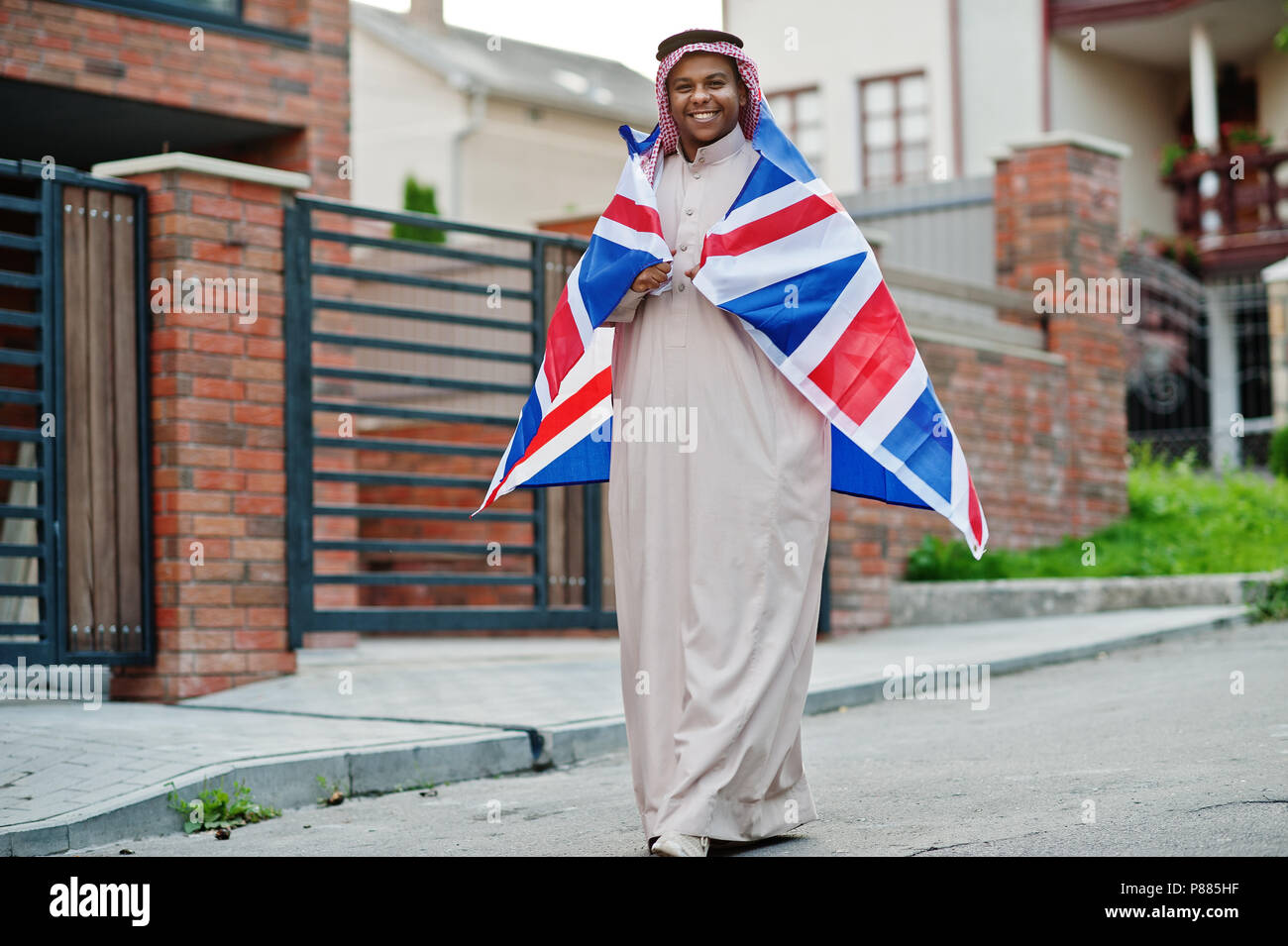 Middle Eastern arab man posed on street with Great Britain flag ...