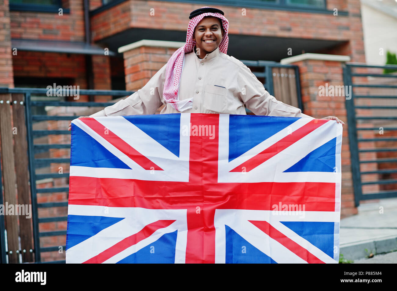 Middle Eastern arab man posed on street with Great Britain flag ...