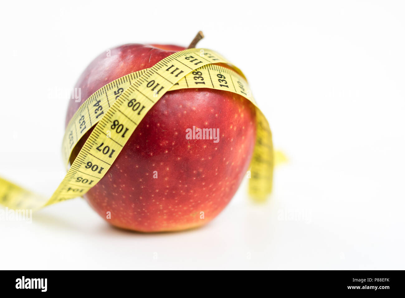 Red apples with a yellow tape measure hi-res stock photography and ...
