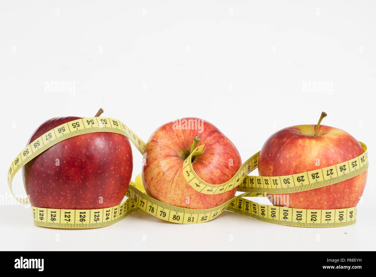 Red apples with a yellow tape measure hi-res stock photography and ...