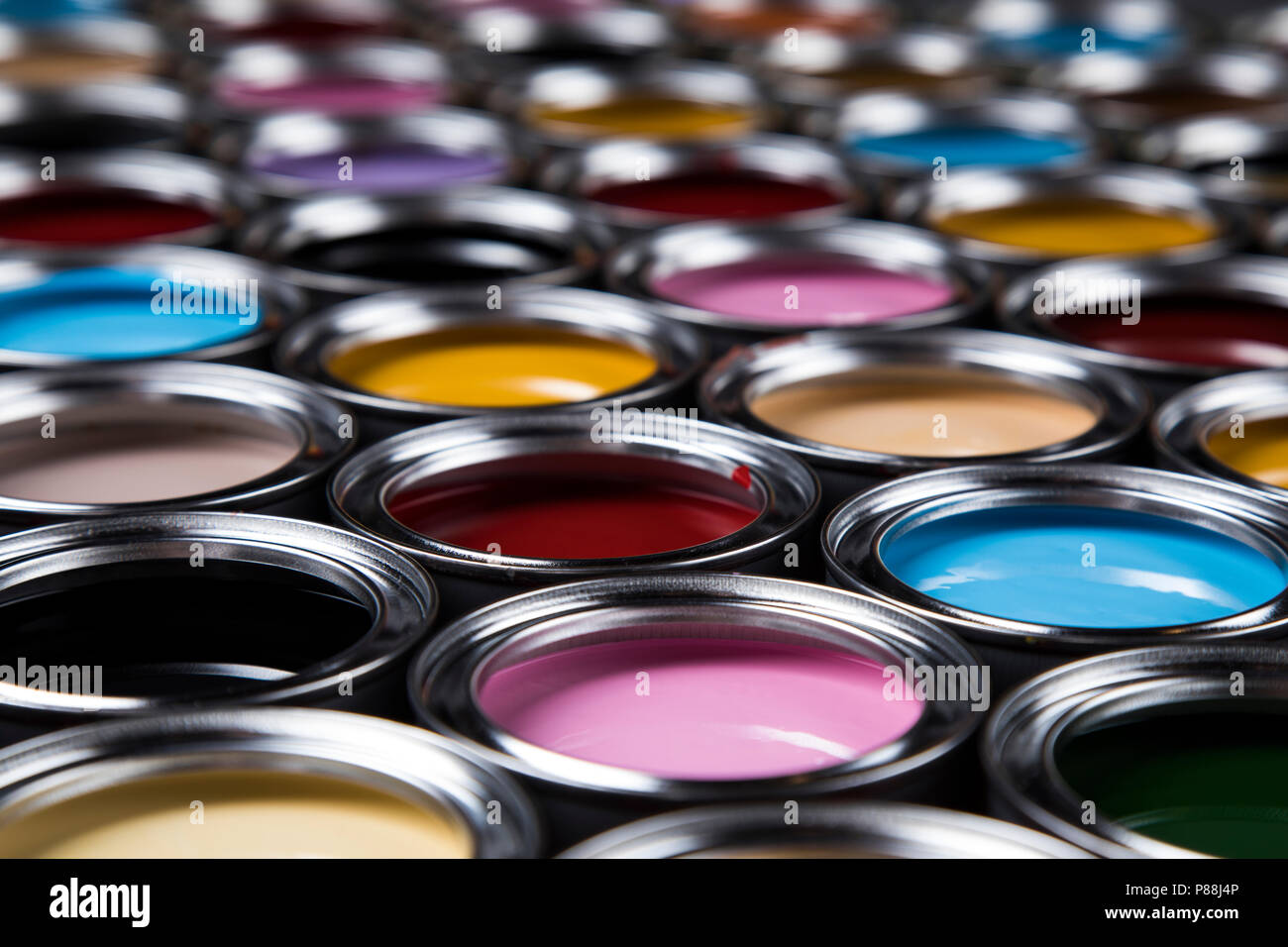 Group of tin metal cans with color paint Stock Photo - Alamy