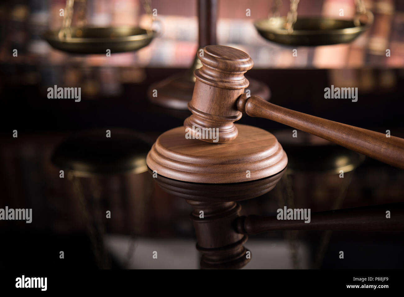 Law theme, mallet of judge, wooden gavel, mirror reflection background ...