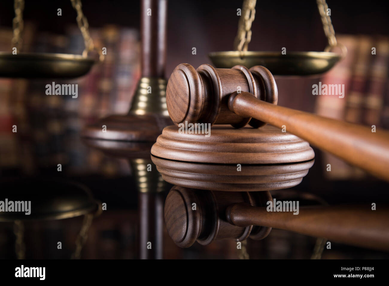 Law theme, mallet of judge, wooden gavel, mirror reflection background ...