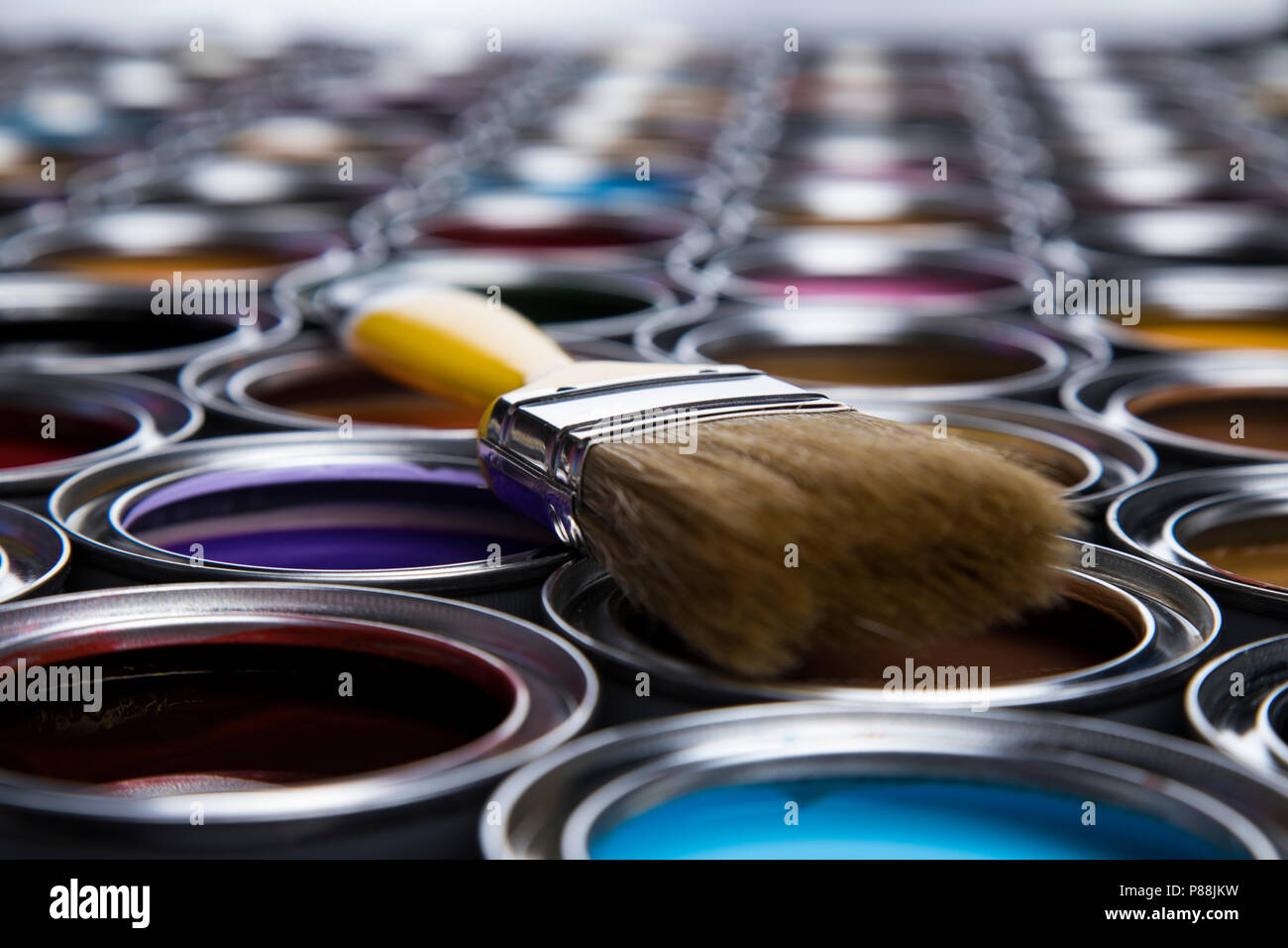 Tin cans with paint, brushes and bright palette of colors Stock Photo ...