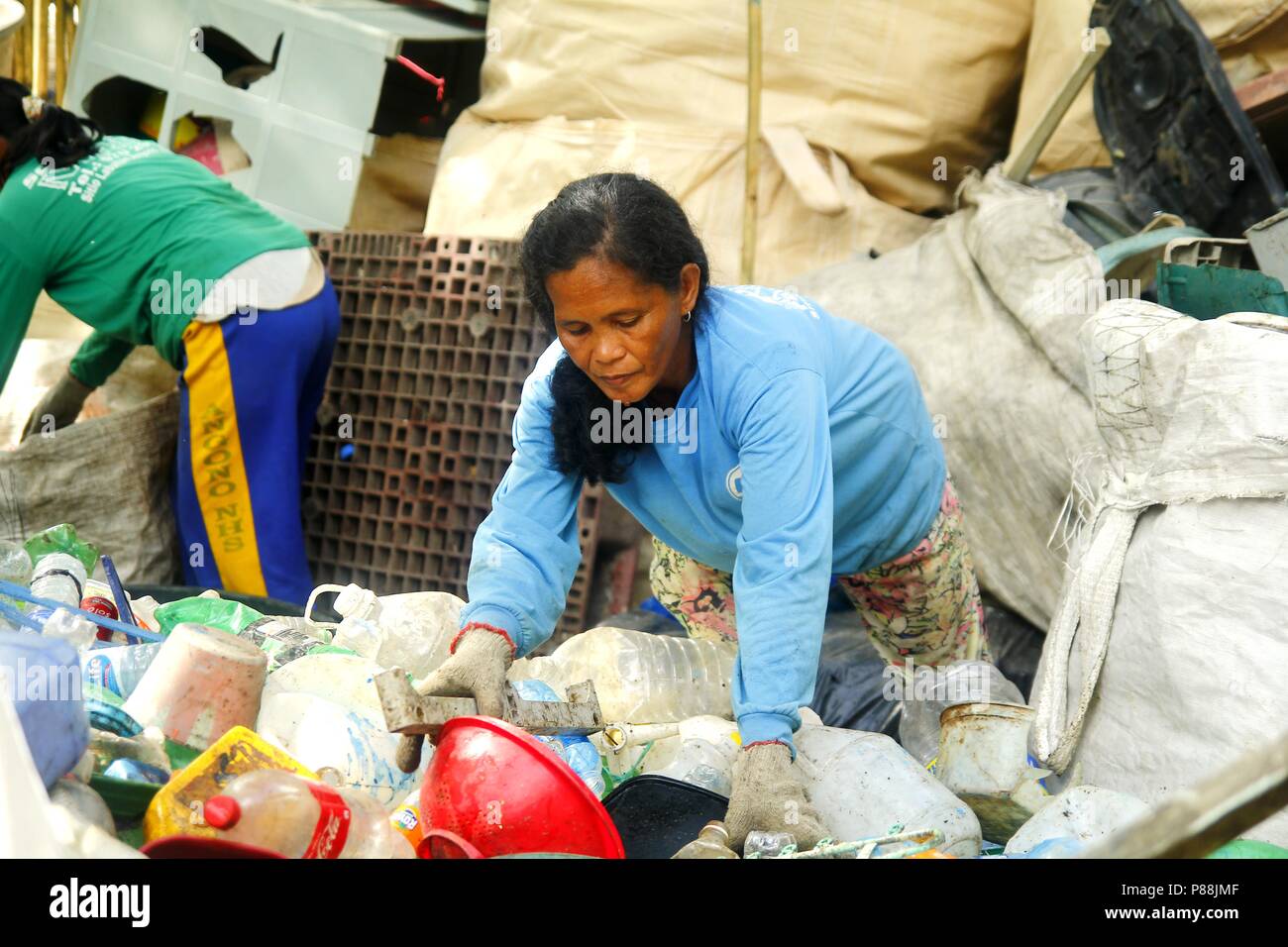 ANGONO, RIZAL, PHILIPPINES - JULY 4 2018: Workers of a materials ...