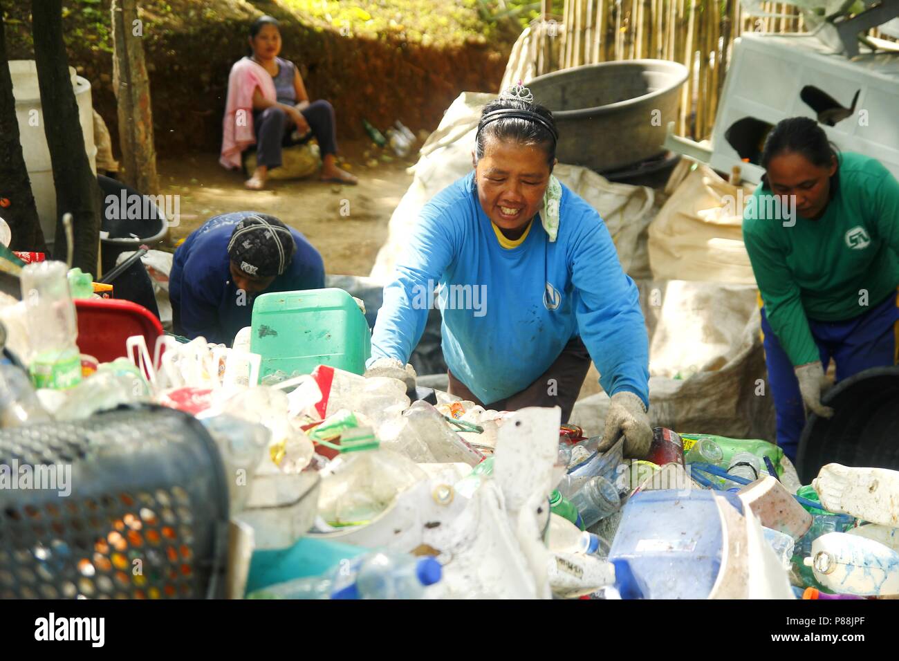ANGONO, RIZAL, PHILIPPINES - JULY 4 2018: Workers of a materials ...