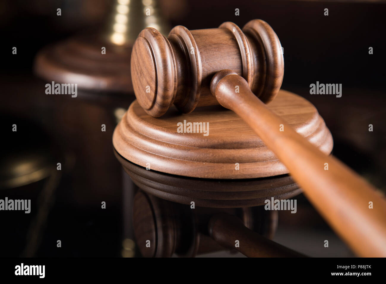 Law theme, mallet of judge, wooden gavel, mirror reflection background ...