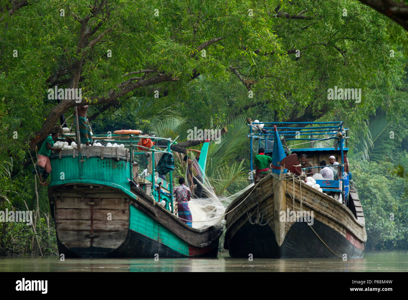 Fishing boats on the canal of The Sundarbans, a UNESCO World Heritage ...