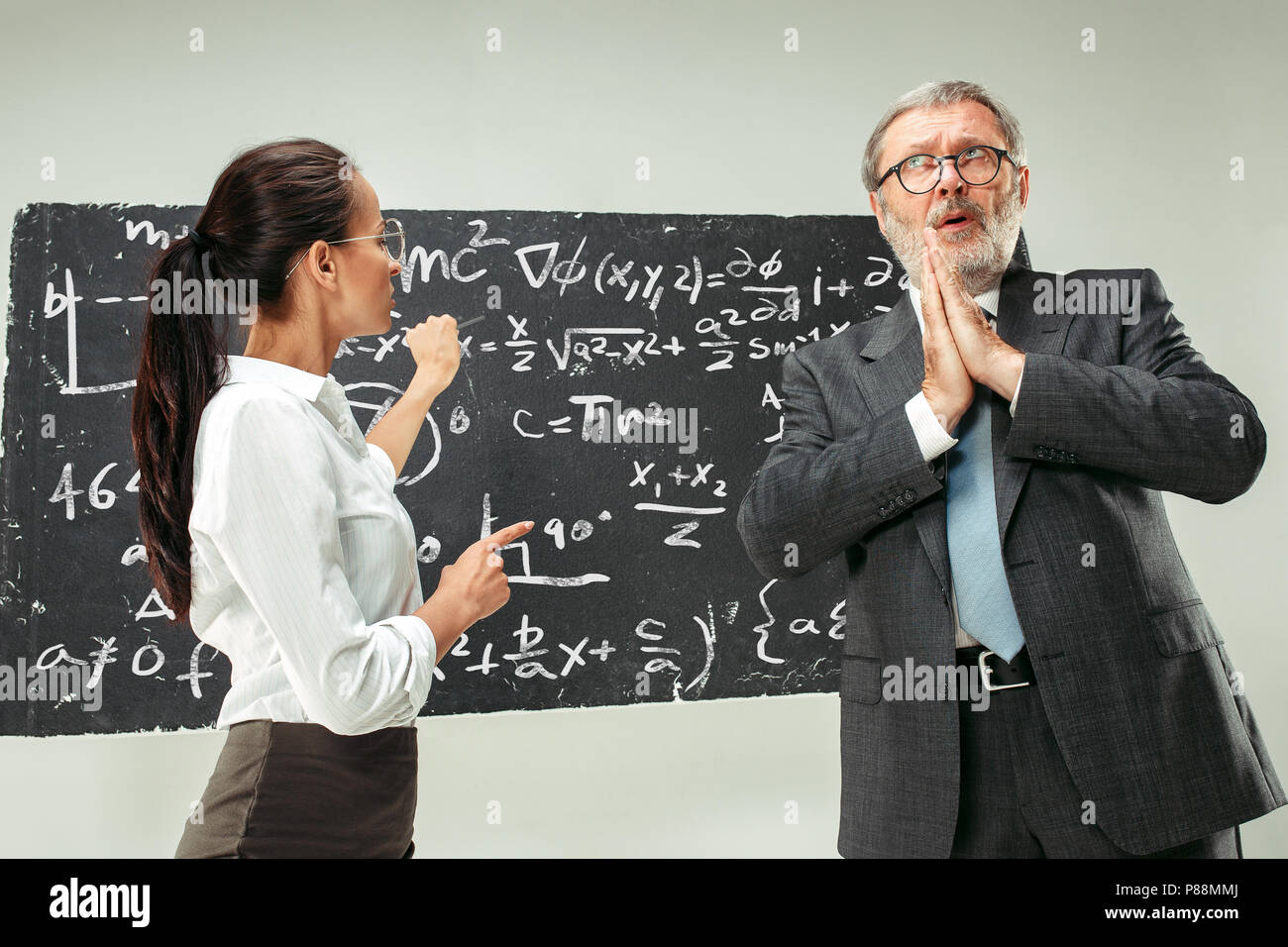 Male professor and young woman against chalkboard in classroom Stock ...