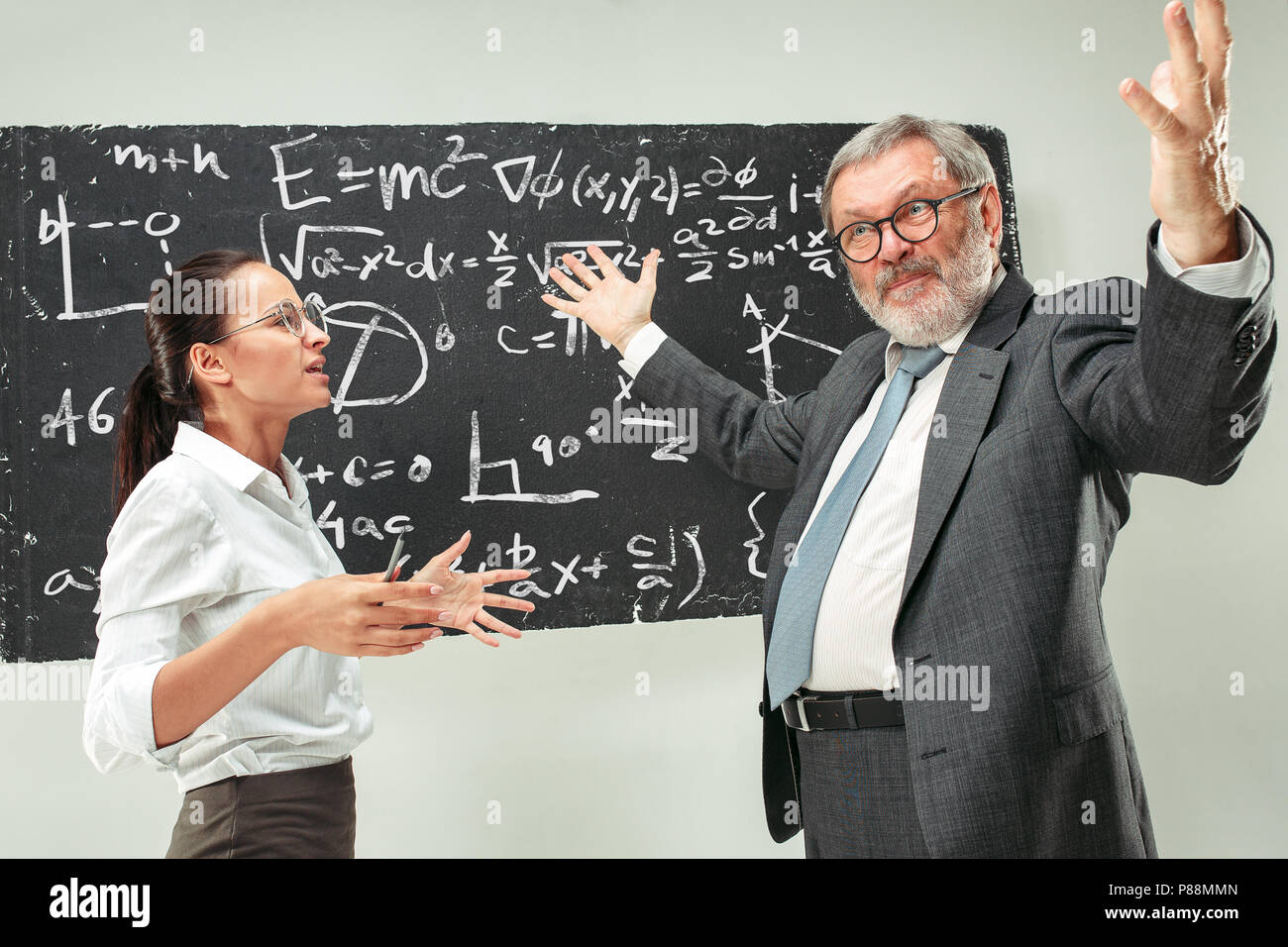Male professor and young woman against chalkboard in classroom Stock ...