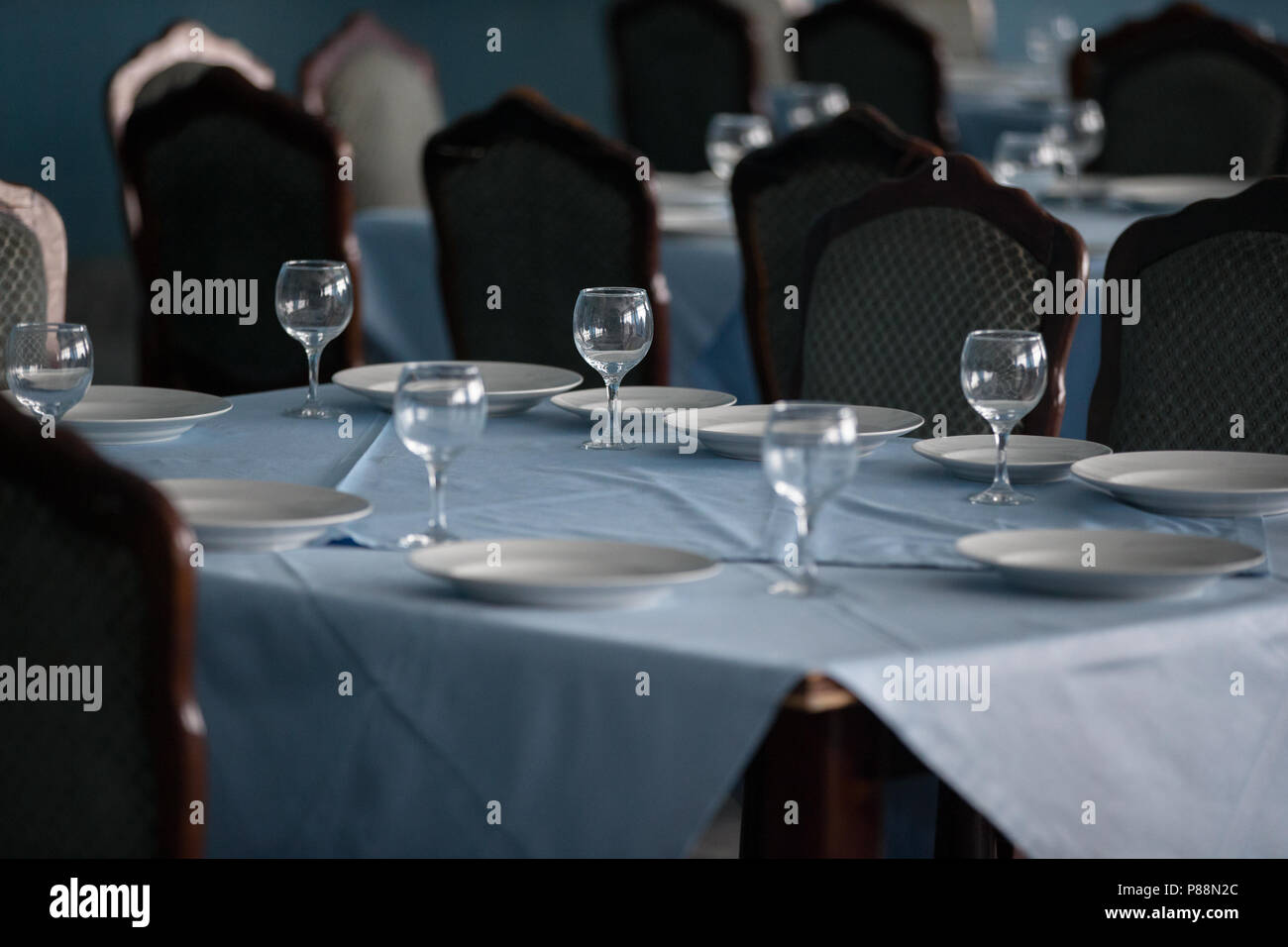Table in the restaurant with empty plates and glass goblets.Empty table ...