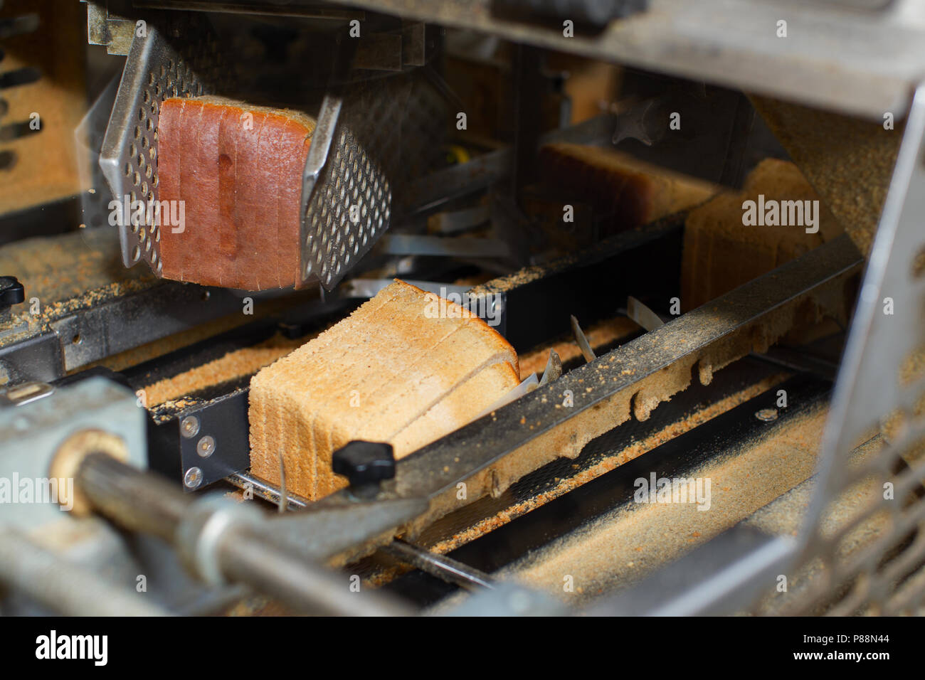 Industrial bread cutting line Stock Photo - Alamy