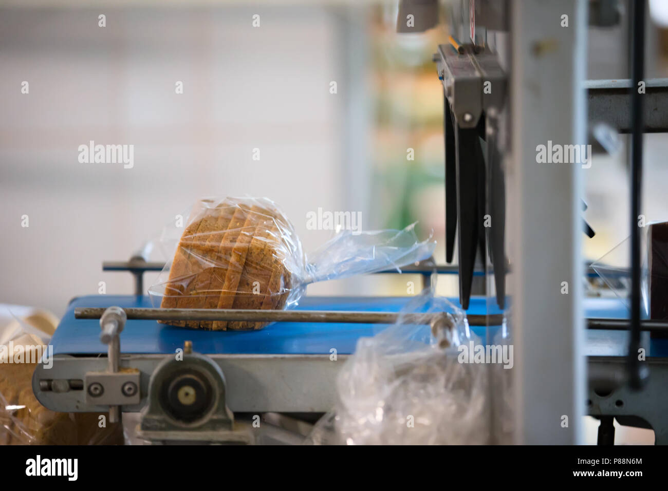 Industrial line for packaging of bakery products. Packing of bread at ...