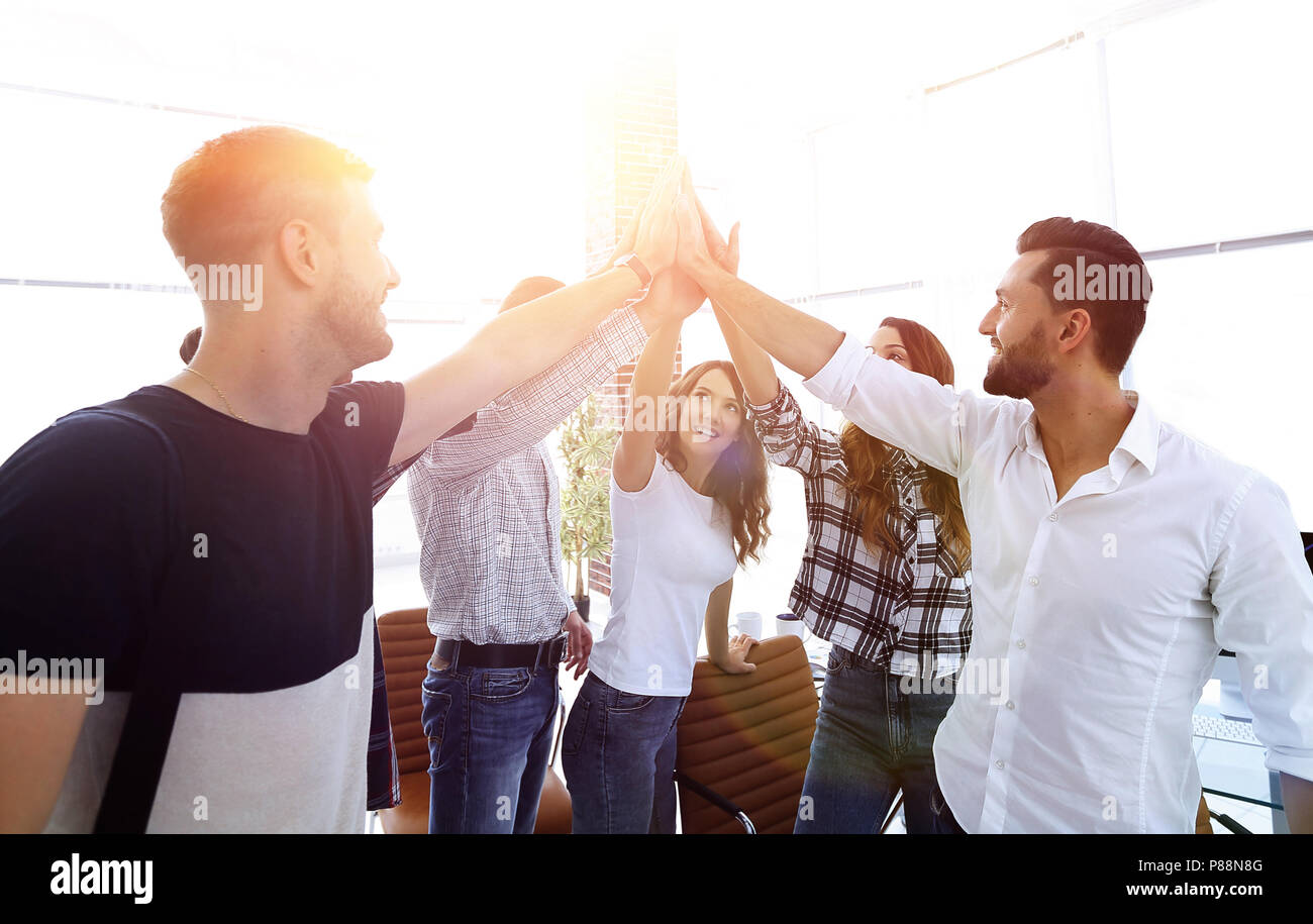 creative team giving each other a high five Stock Photo - Alamy