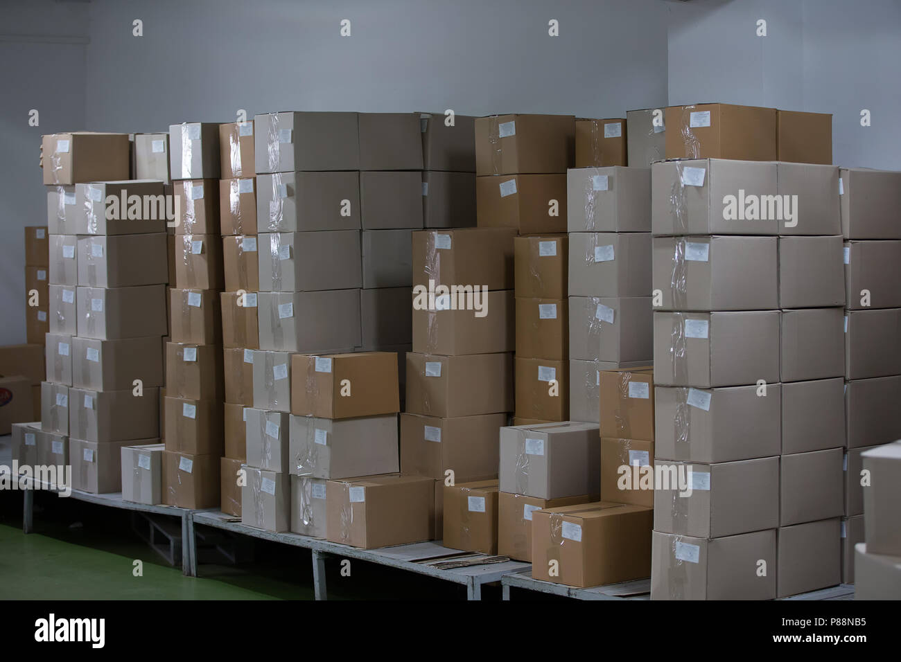 Warehouse with cardboard boxes Stock Photo - Alamy