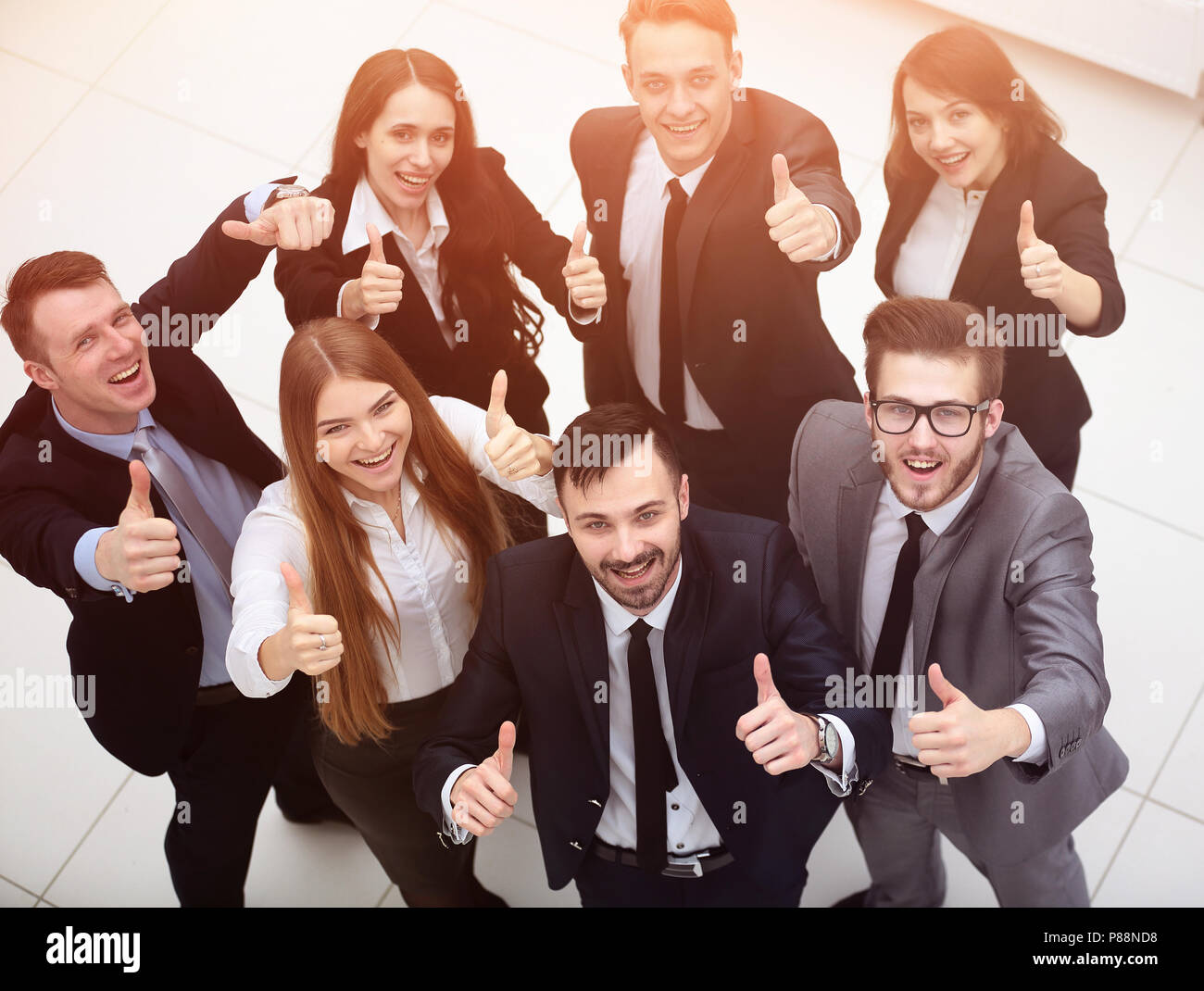 successful business team holding up a thumbs up Stock Photo - Alamy