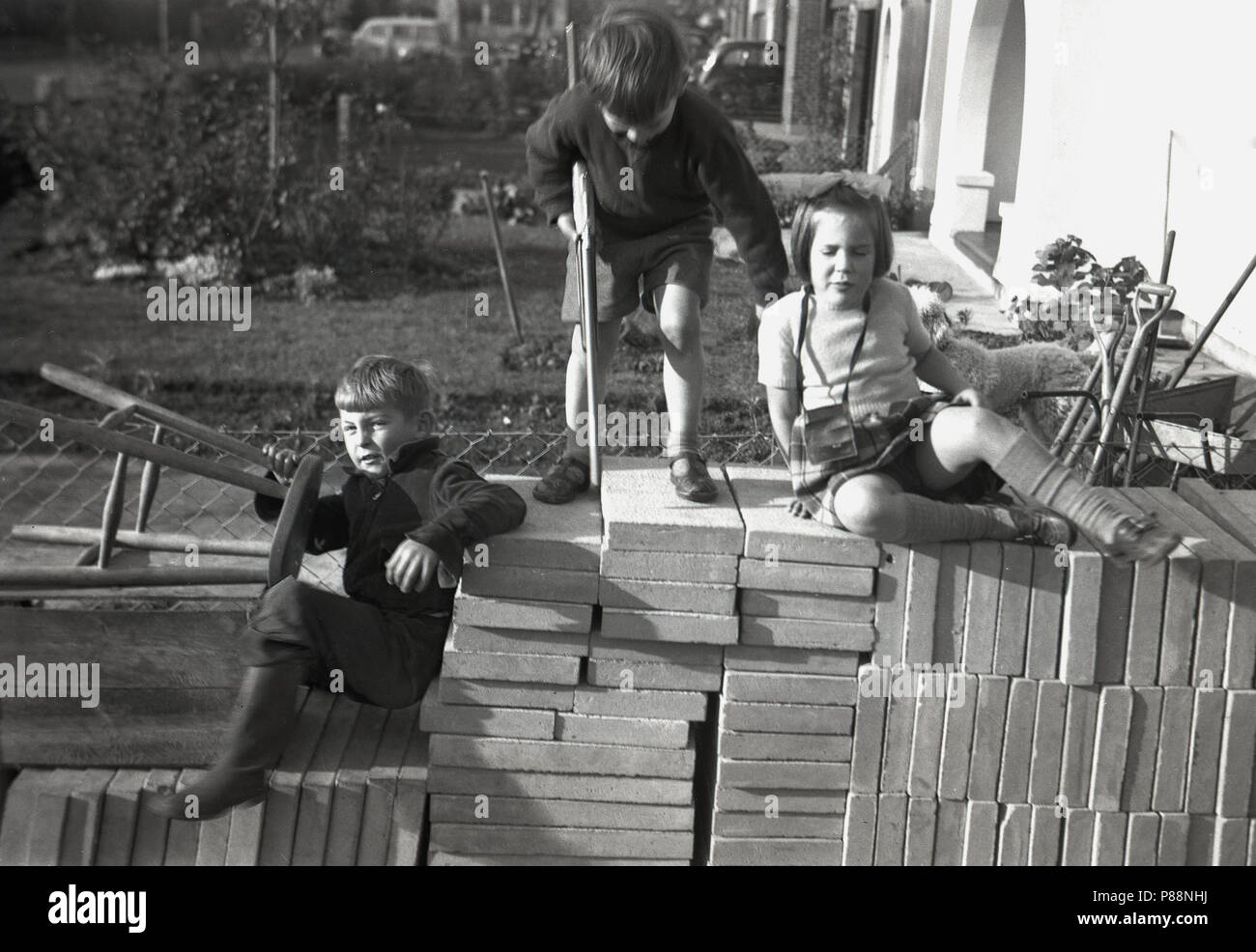 children climbing over garden paving stones Stock Photo - Alamy