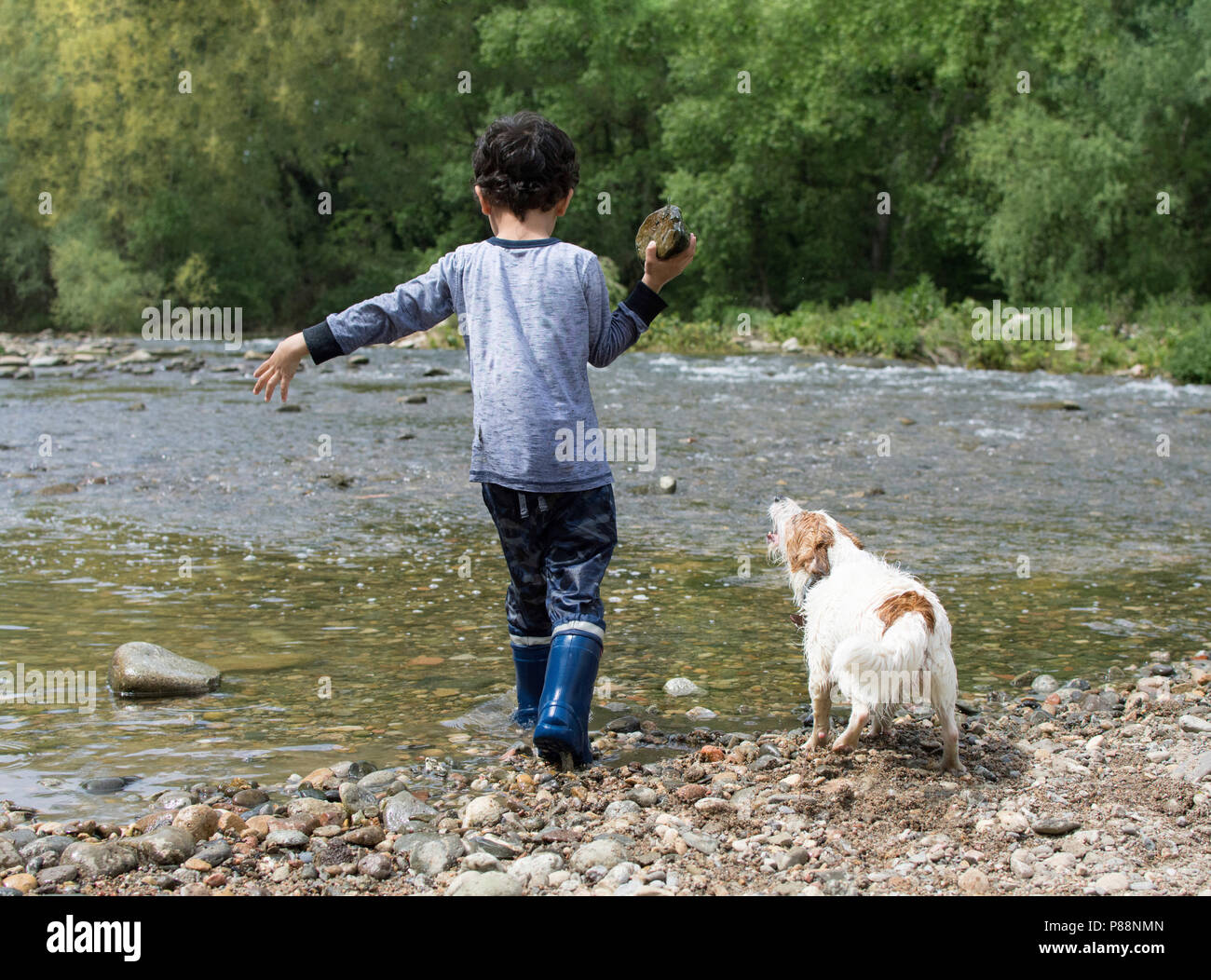 Children throwing stones hi-res stock photography and images - Alamy