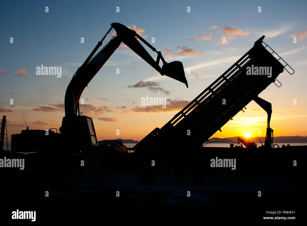 track-type loader excavator machine doing earthmoving work at sand ...