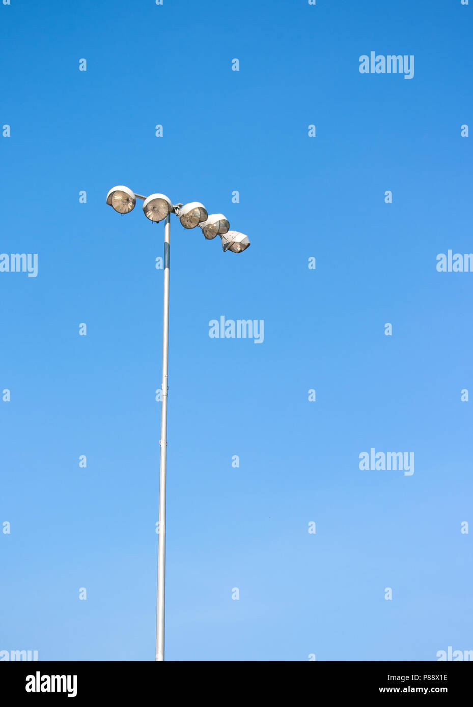 Spot light tower in blue sky Stock Photo - Alamy