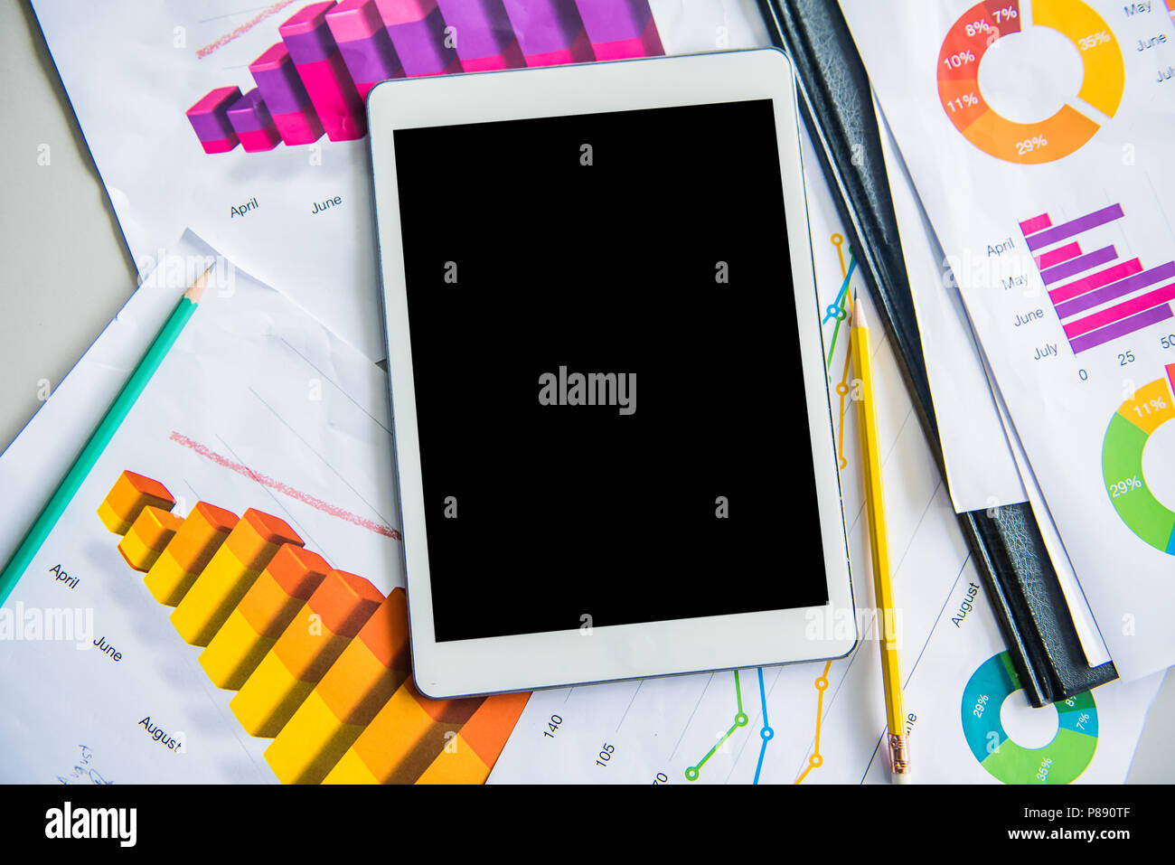 empty tablet on the table with paper chart Stock Photo - Alamy