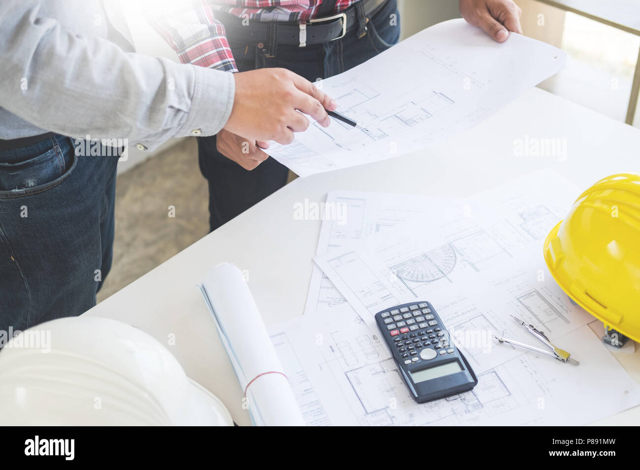 Close-up Of Person's engineer Hand Drawing Plan On Blue Print with ...