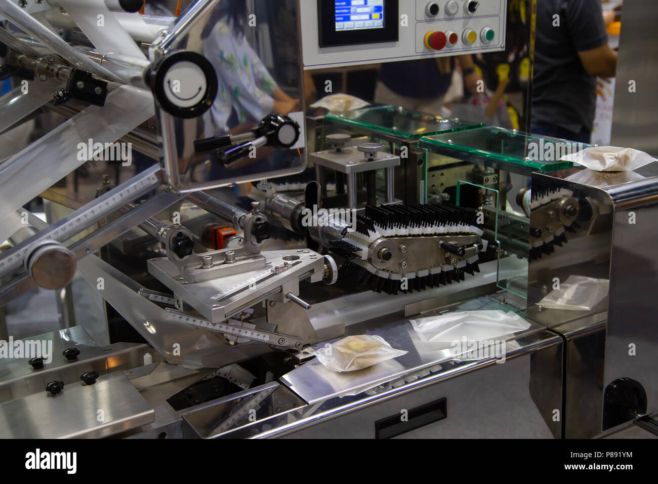 Cake plastic wrapping machine on bakery production line Stock Photo - Alamy