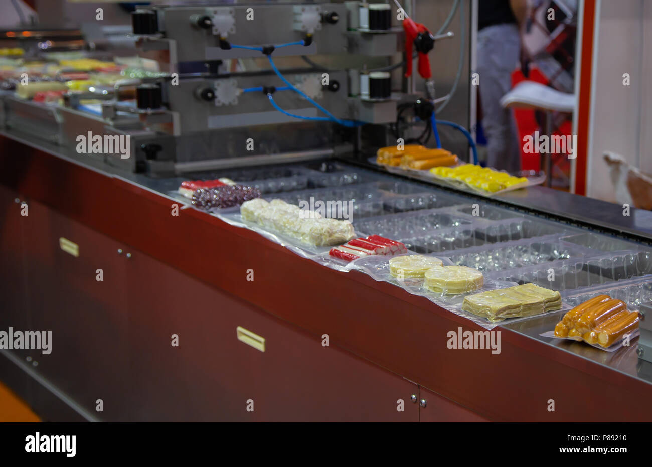 Packing food sausage and ham in production line Stock Photo - Alamy