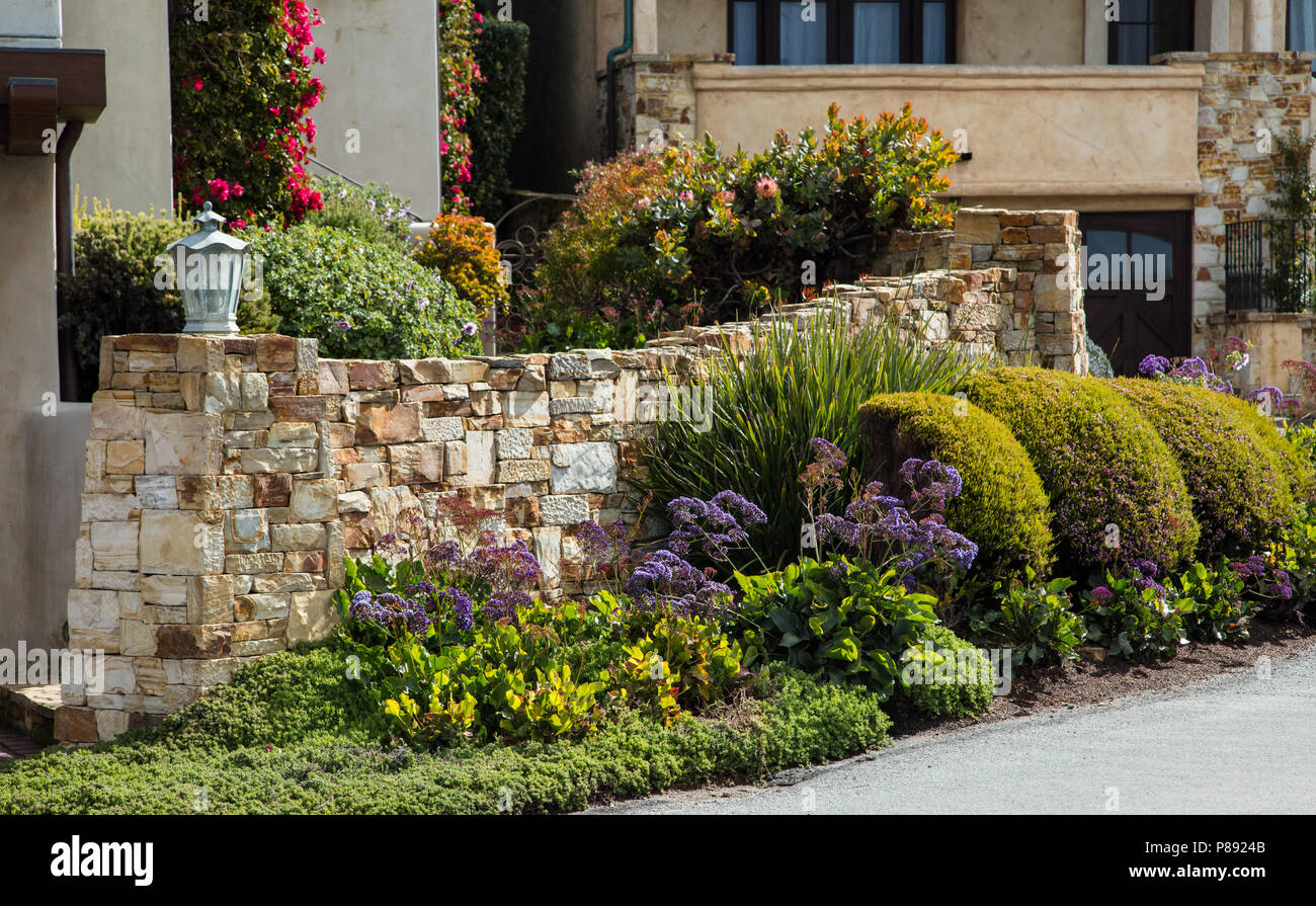 Home landscaping example with a garden wall featuring intricate stone ...