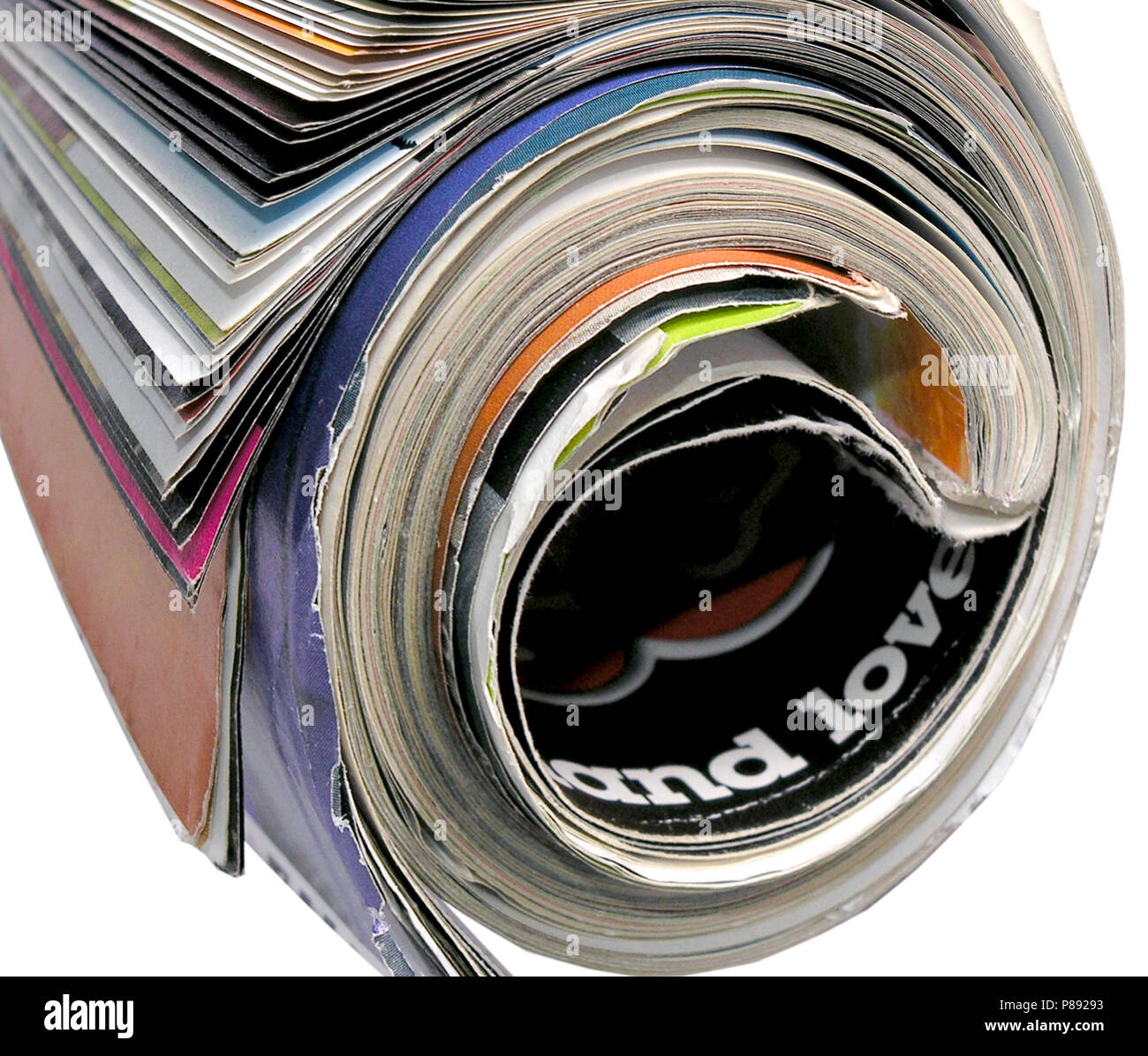 macro of a scruffy old roled up magazine on white Stock Photo - Alamy