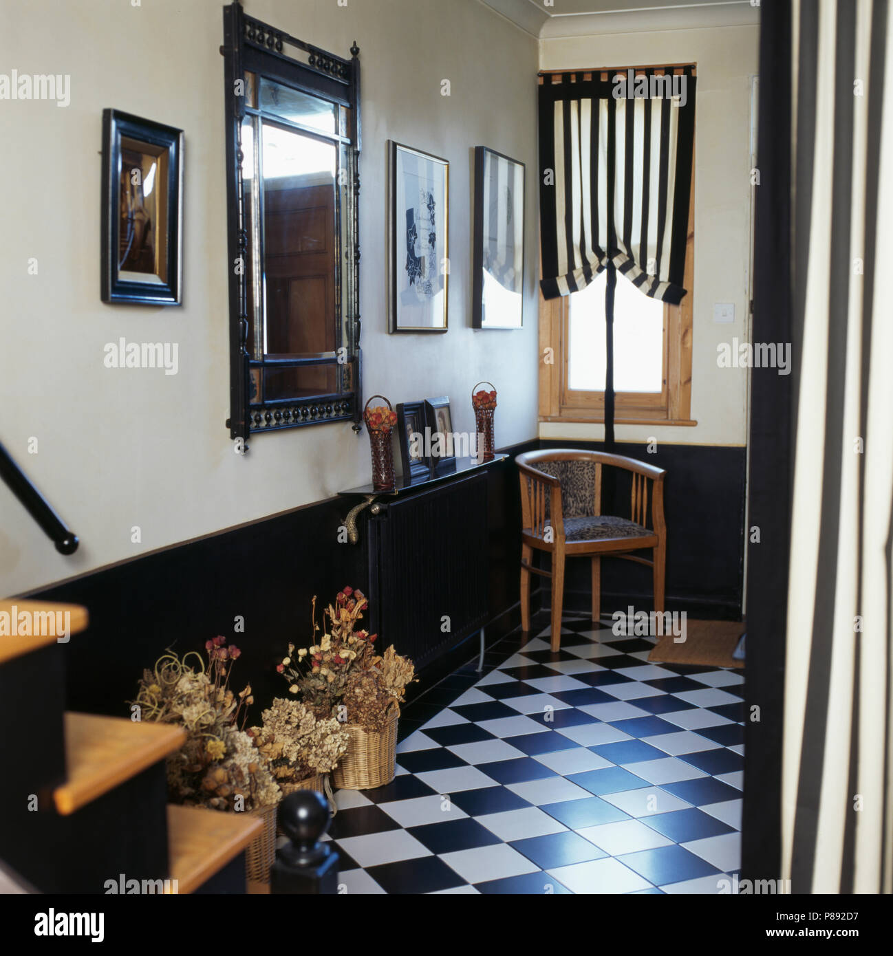 Black+white chequerboard tiled floor in monochromatic hall with black ...