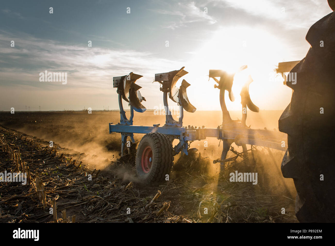 Tractor plowing fields -preparing land for sowing Stock Photo - Alamy